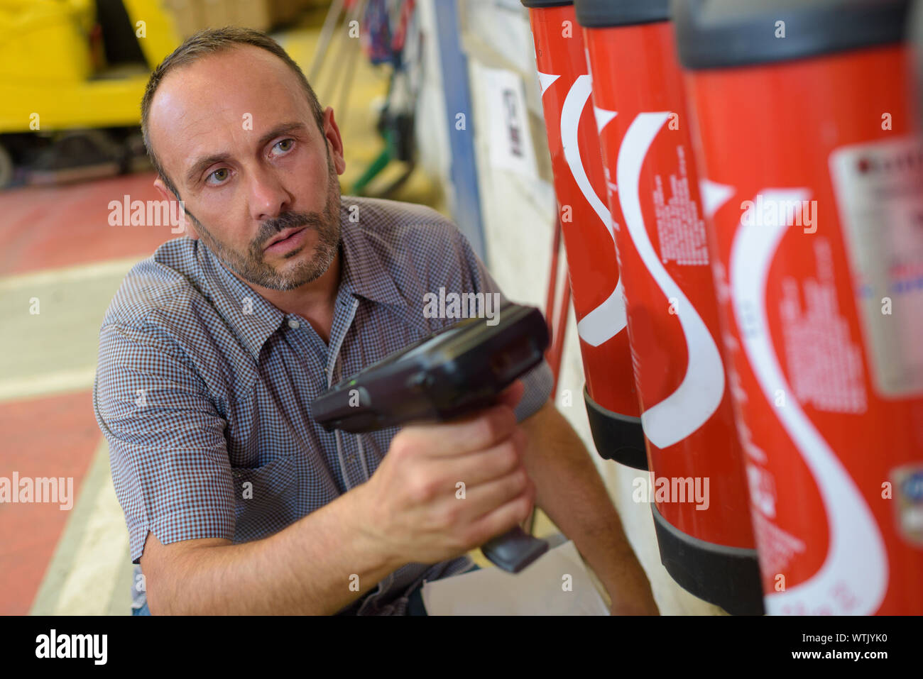 male worker using handheld scanner in warehouse Stock Photo - Alamy