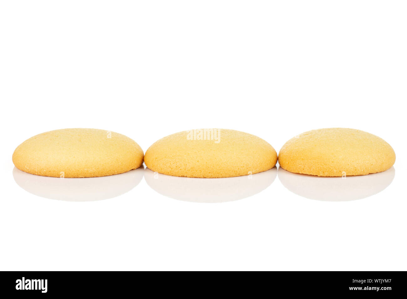 Group of three whole sweet golden sponge biscuit isolated on white ...