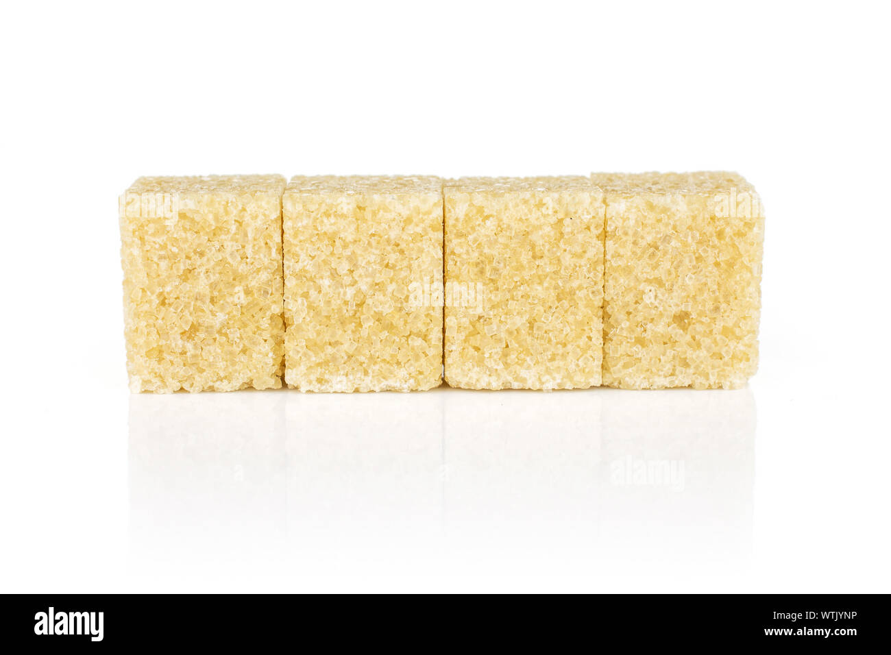 Group of four whole sweet brown sugar cube isolated on white background ...
