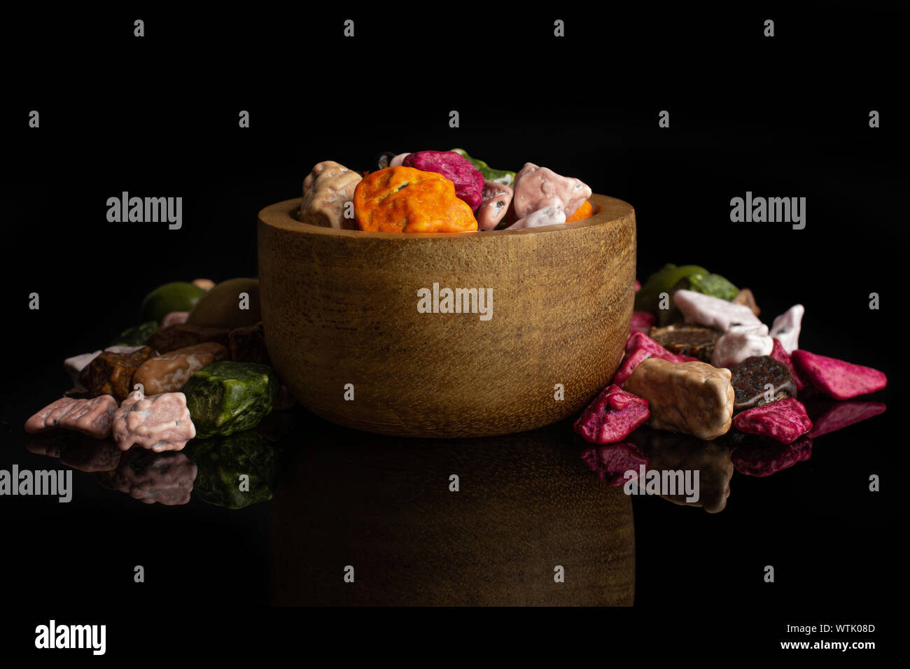 Lot of whole sweet chocolate stone in tiny wooden bowl isolated on ...