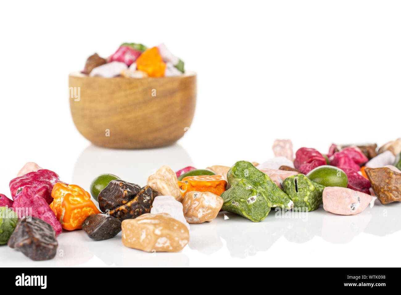 Lot of whole sweet chocolate stone in tiny wooden bowl isolated on ...