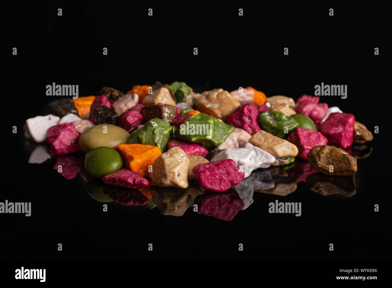 Lot of whole sweet chocolate stone isolated on black glass Stock Photo ...
