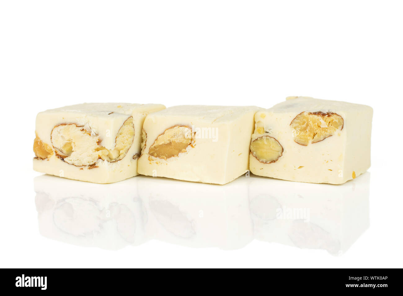Group of three whole sweet white nougat in row isolated on white ...