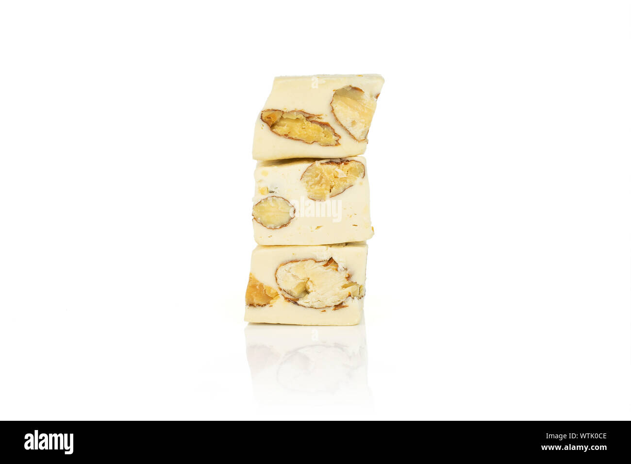 Group of three whole sweet white nougat in column isolated on white ...