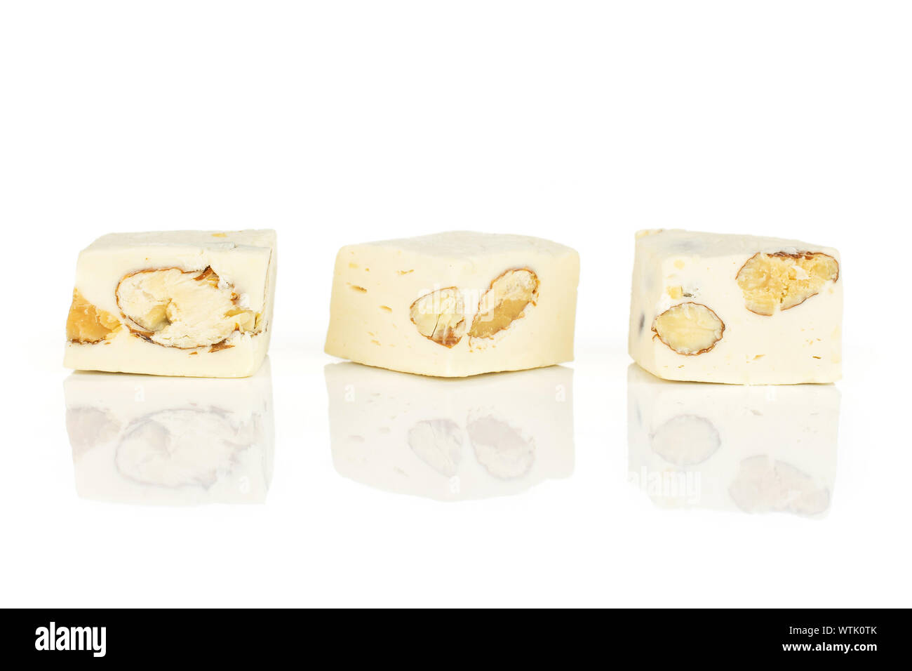 Group of three whole sweet white nougat in row isolated on white ...