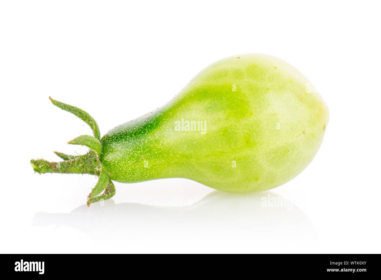 One whole unripe fresh yellow pear tomato isolated on white background ...