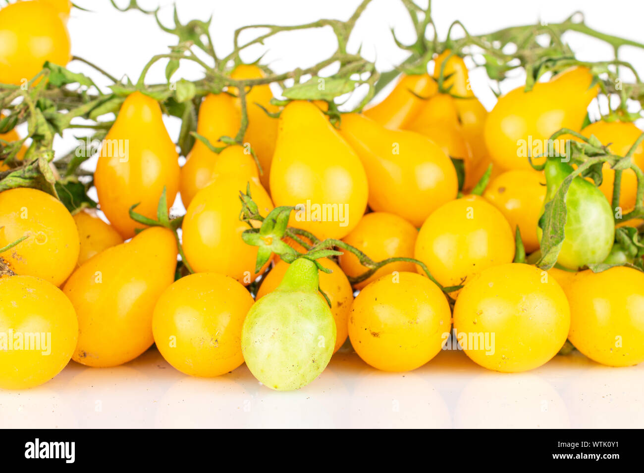 Lot of whole fresh yellow pear tomato on branch isolated on white ...