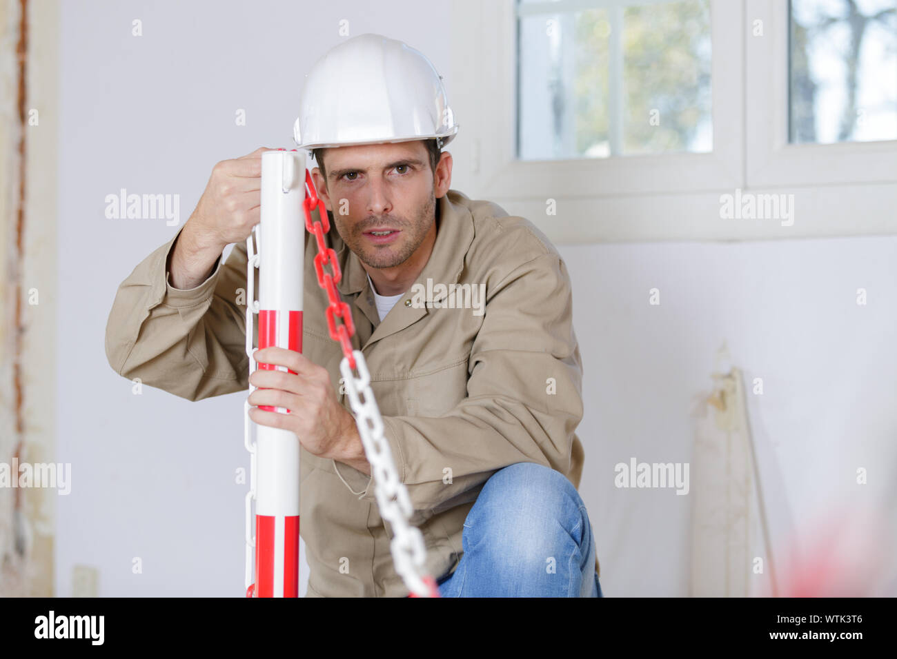 caucasian worker holding chain at construction site Stock Photo - Alamy