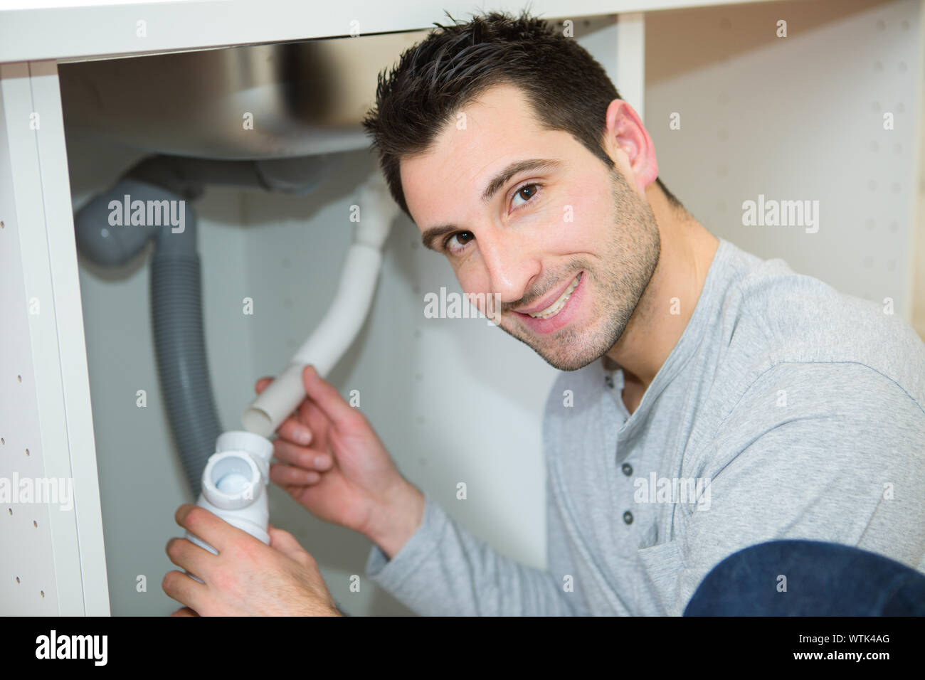 happy mechanic man fixing pipes Stock Photo - Alamy