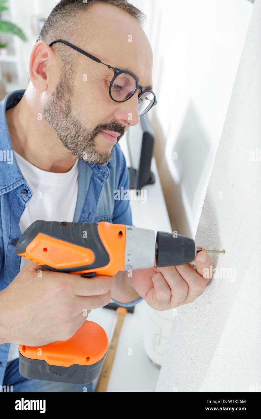 mature man using cordless screwdriver Stock Photo - Alamy