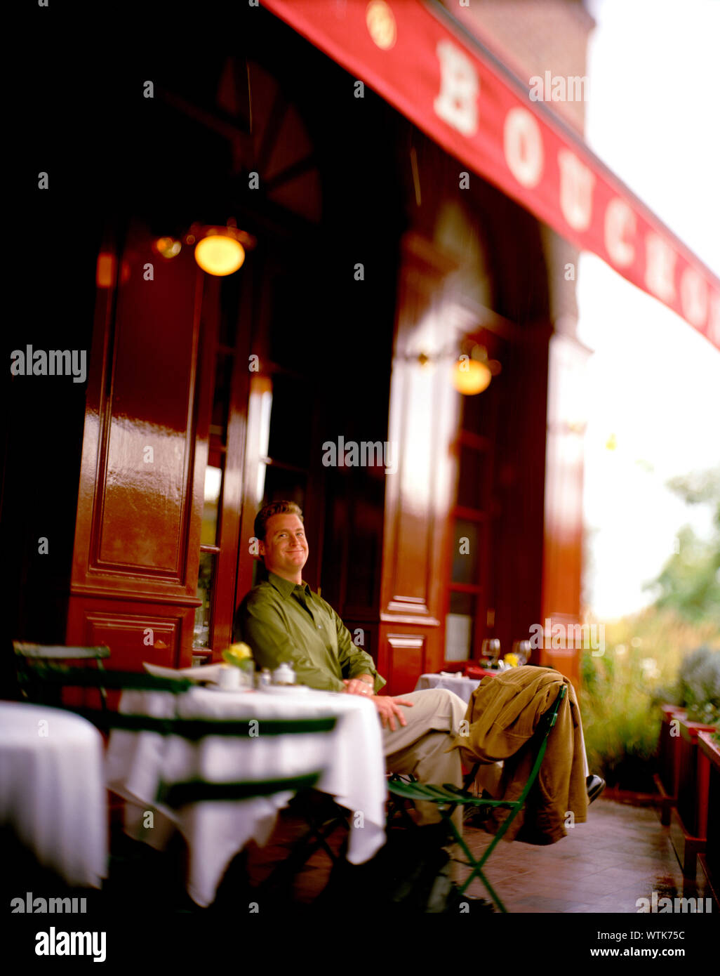 Man sitting outside at restaurant Stock Photo - Alamy