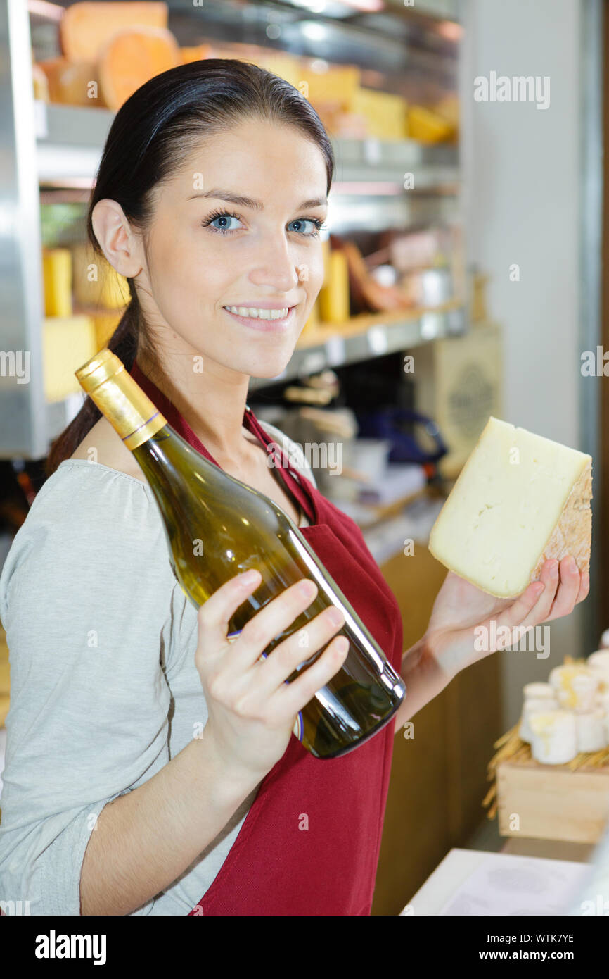happy female brunette with different types of cheese in gastronomy ...