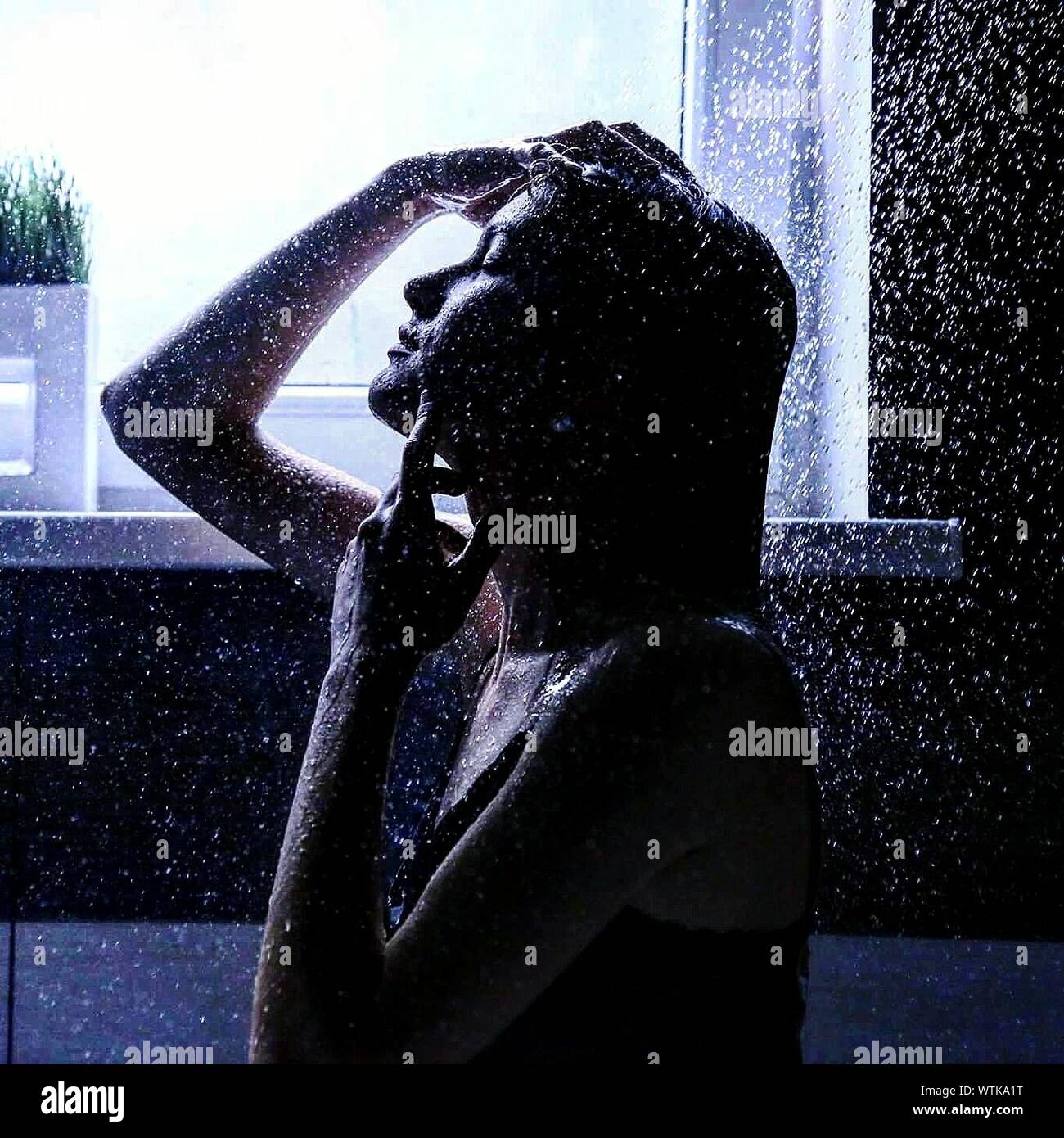 Person in shower hi-res stock photography and images - Alamy