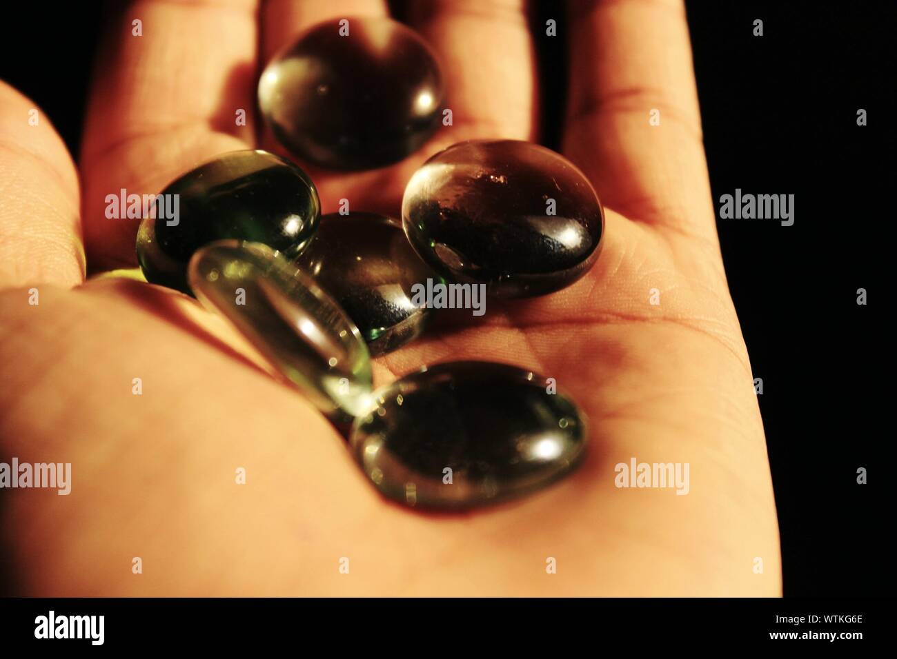 Hand holding marbles hi-res stock photography and images - Alamy