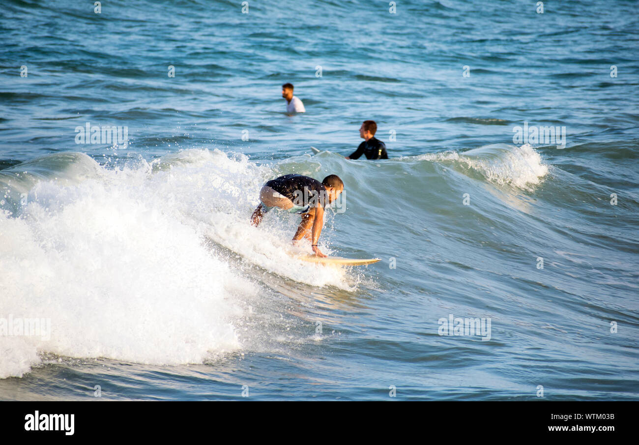 Alicante, Spain, August 25, 2019: Surfer rides a wave in the ...