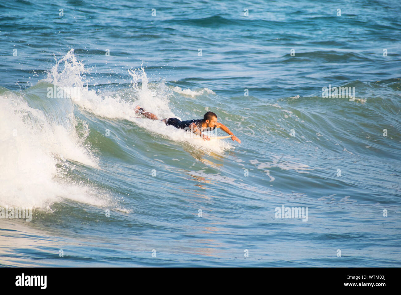 Alicante, Spain, August 25, 2019: Surfer rides a wave in the ...
