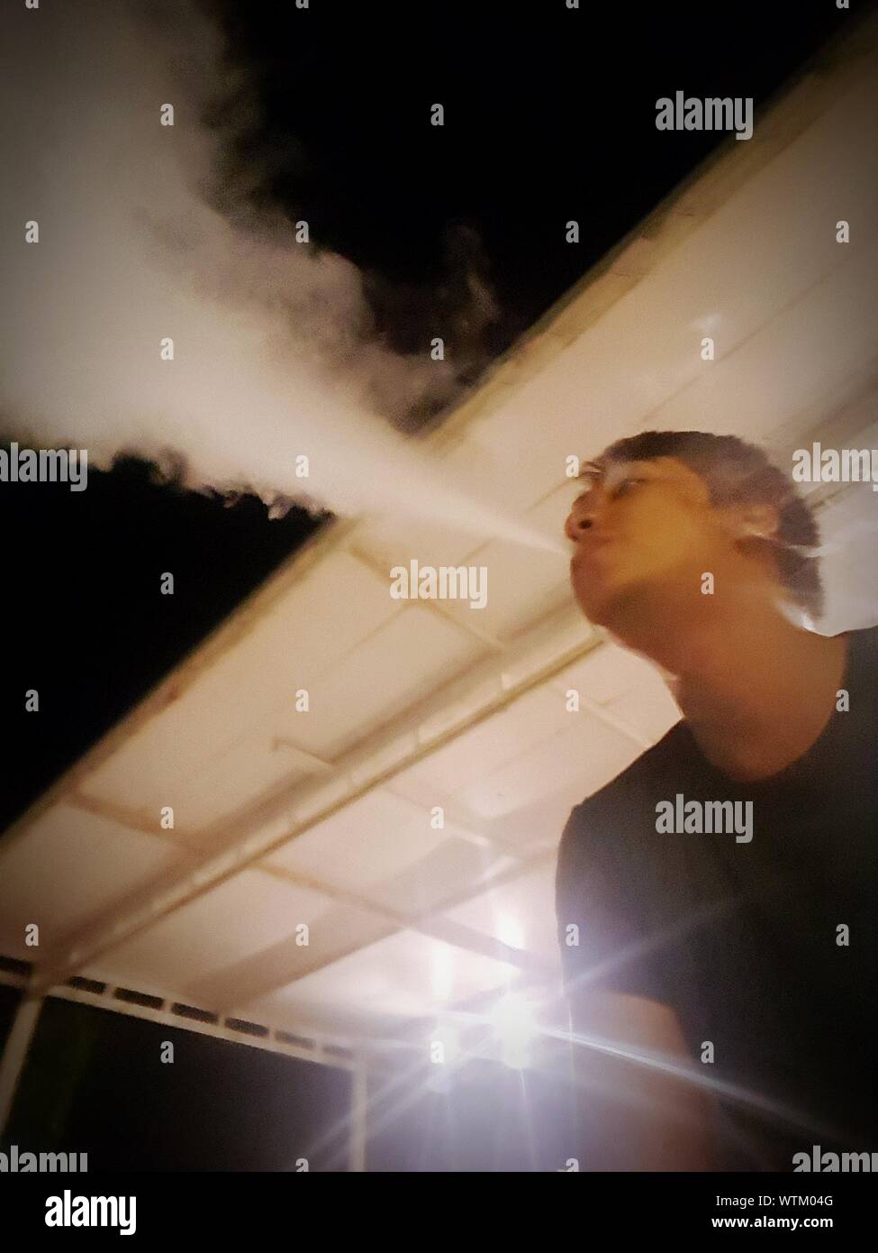 Man exhaling smoke hi-res stock photography and images - Alamy