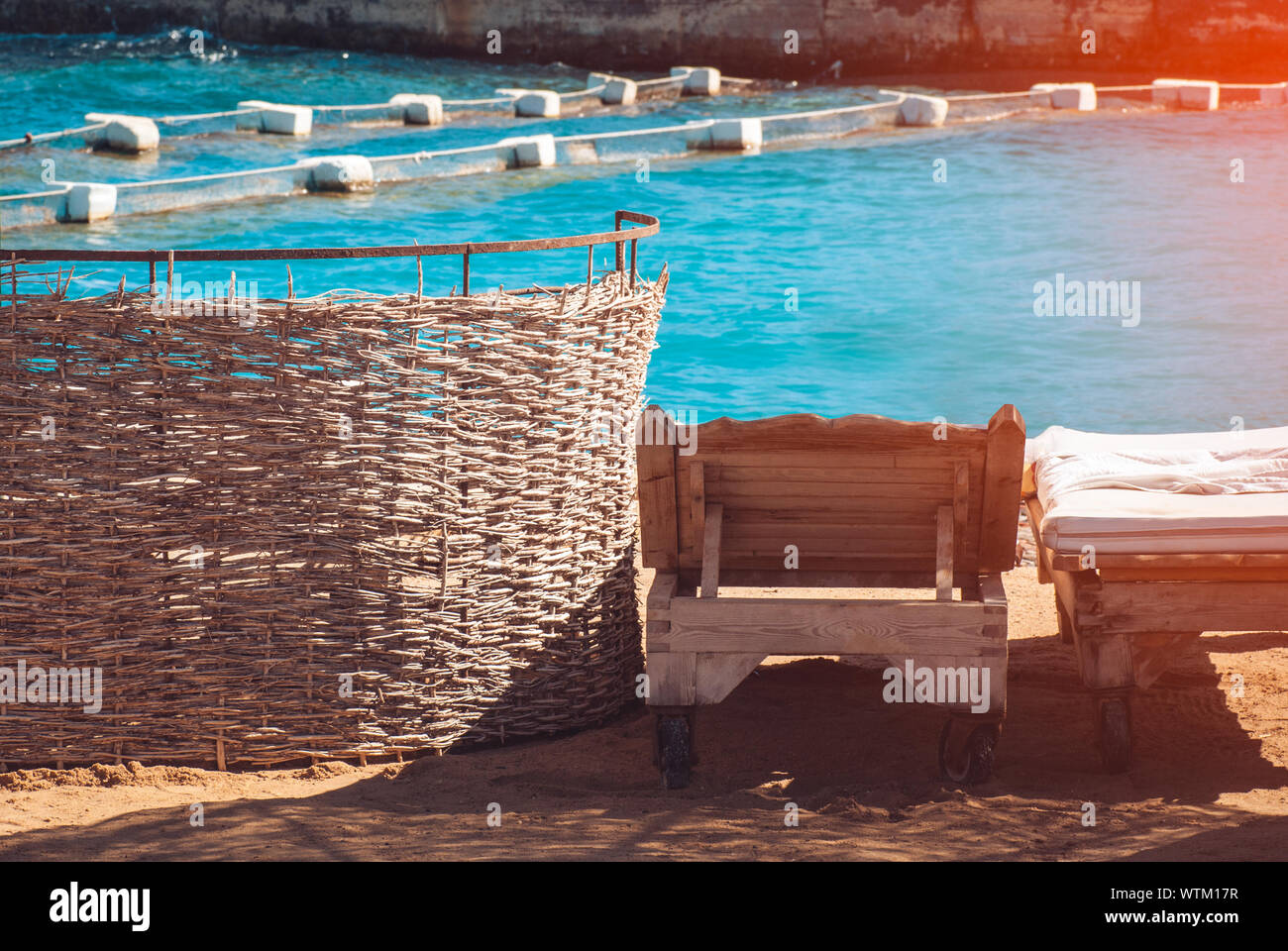 Two wooden empty sunbed with wrapped towels on a beautiful beach in ...