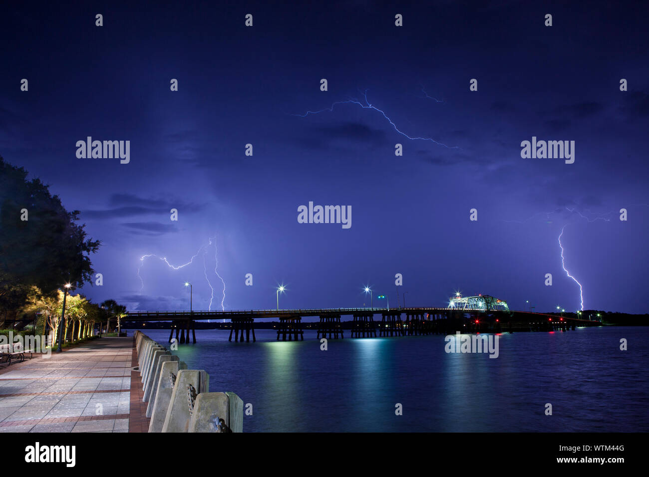 lightning striking over bridge at night Stock Photo - Alamy