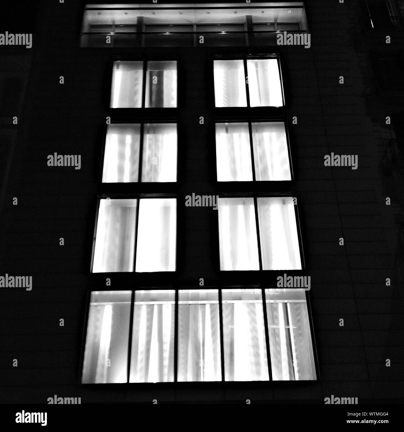 Illuminated Window Of House Stock Photo - Alamy