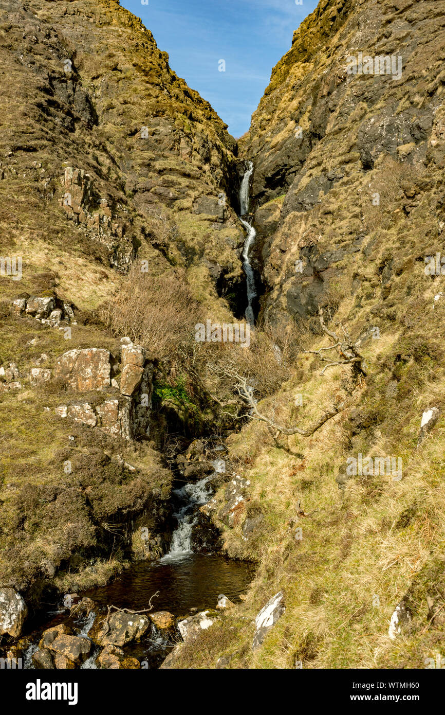 A waterfall in a ravine, above the Treshnish Peninsula coastal walk ...