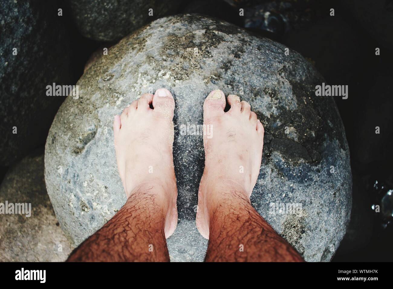 Man standing barefoot on rock hi-res stock photography and images - Alamy