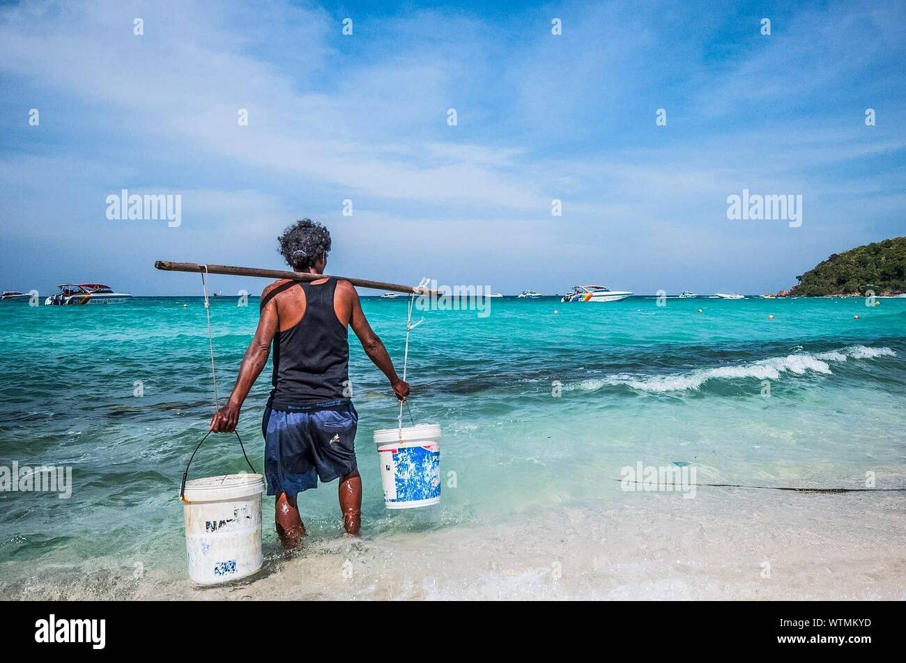 Men carrying buckets hi-res stock photography and images - Alamy