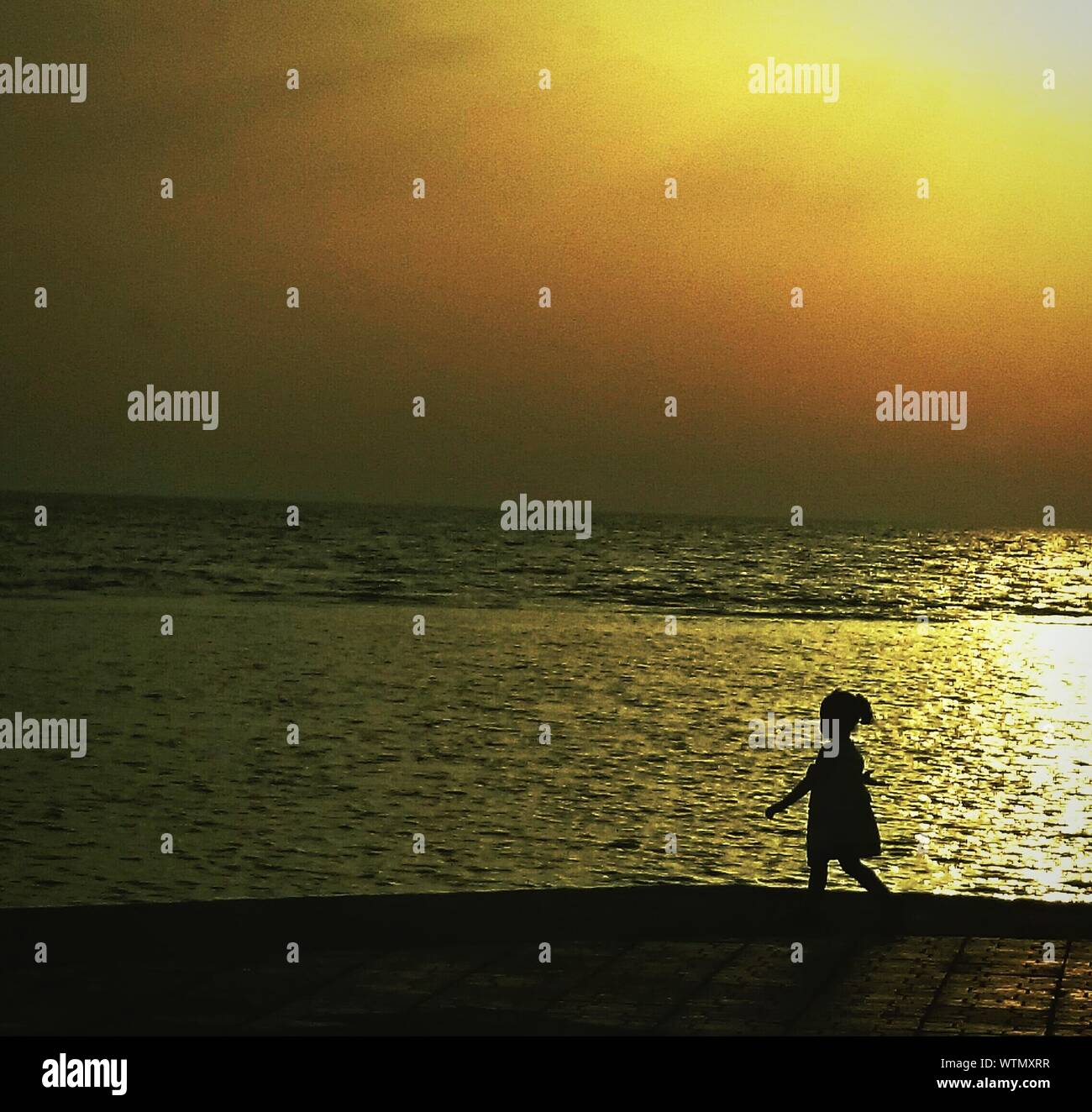 Girl walking at sunset hi-res stock photography and images - Alamy
