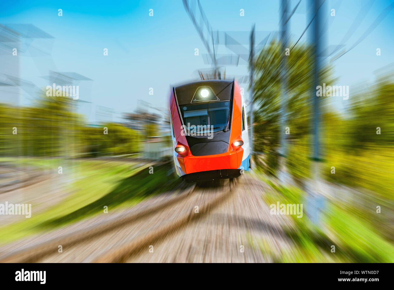 Modern high-speed train moves fast sunny day time Stock Photo - Alamy