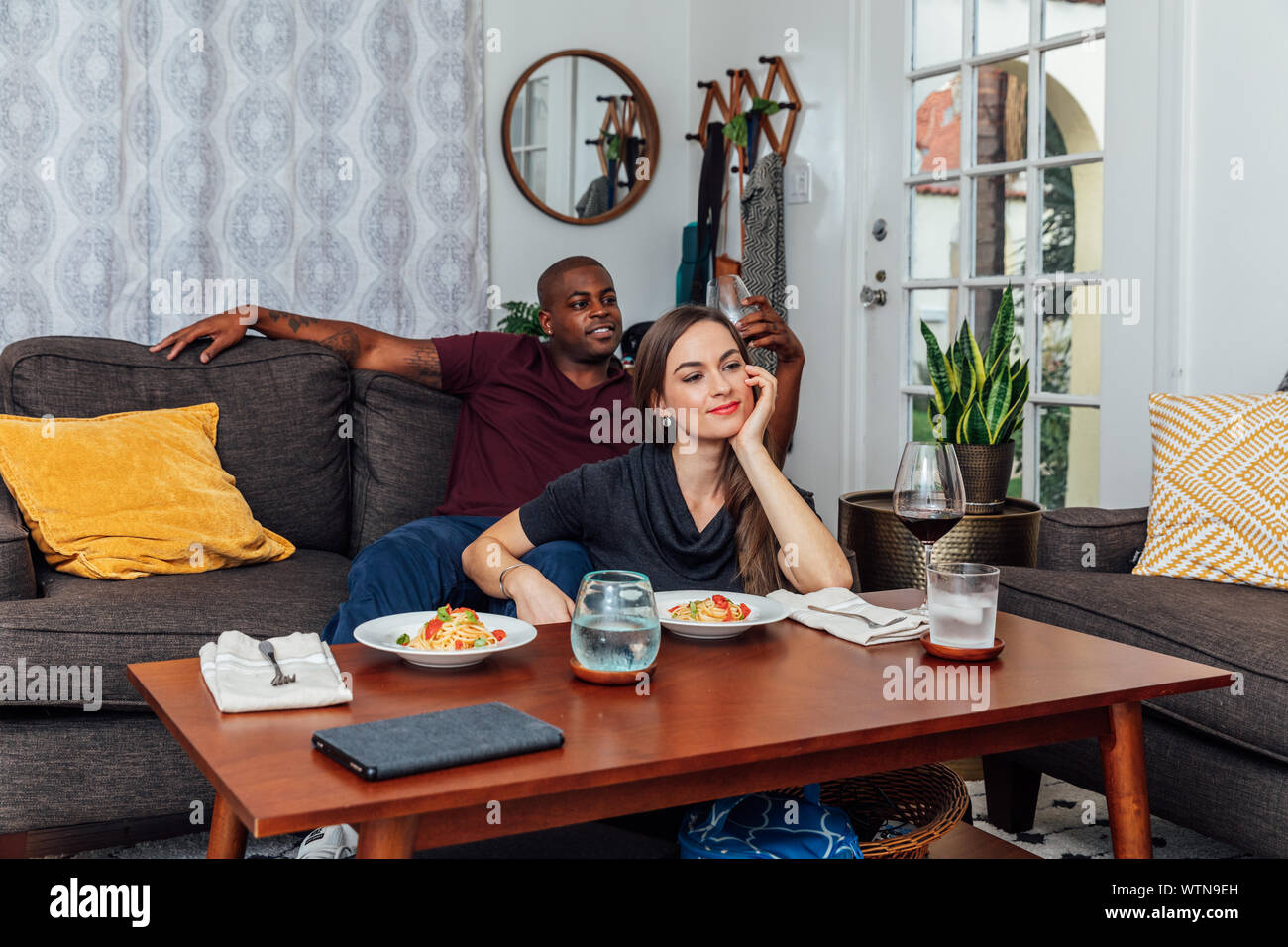Couple having dinner and watching tv Stock Photo - Alamy