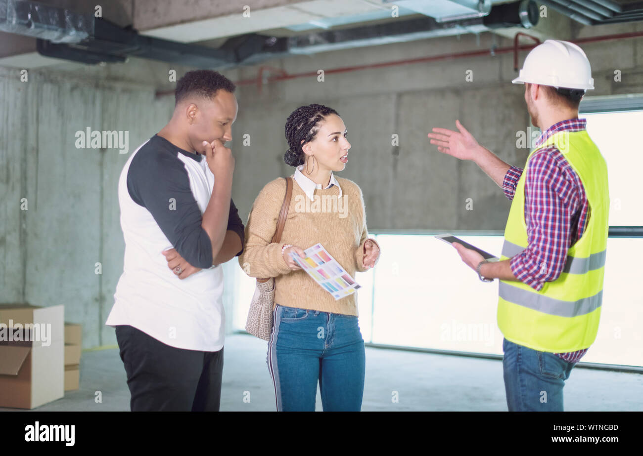 architect engineer using tablet computer while showing house design ...
