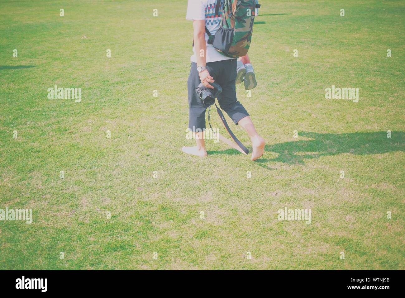 Man walking with camera hi-res stock photography and images - Alamy