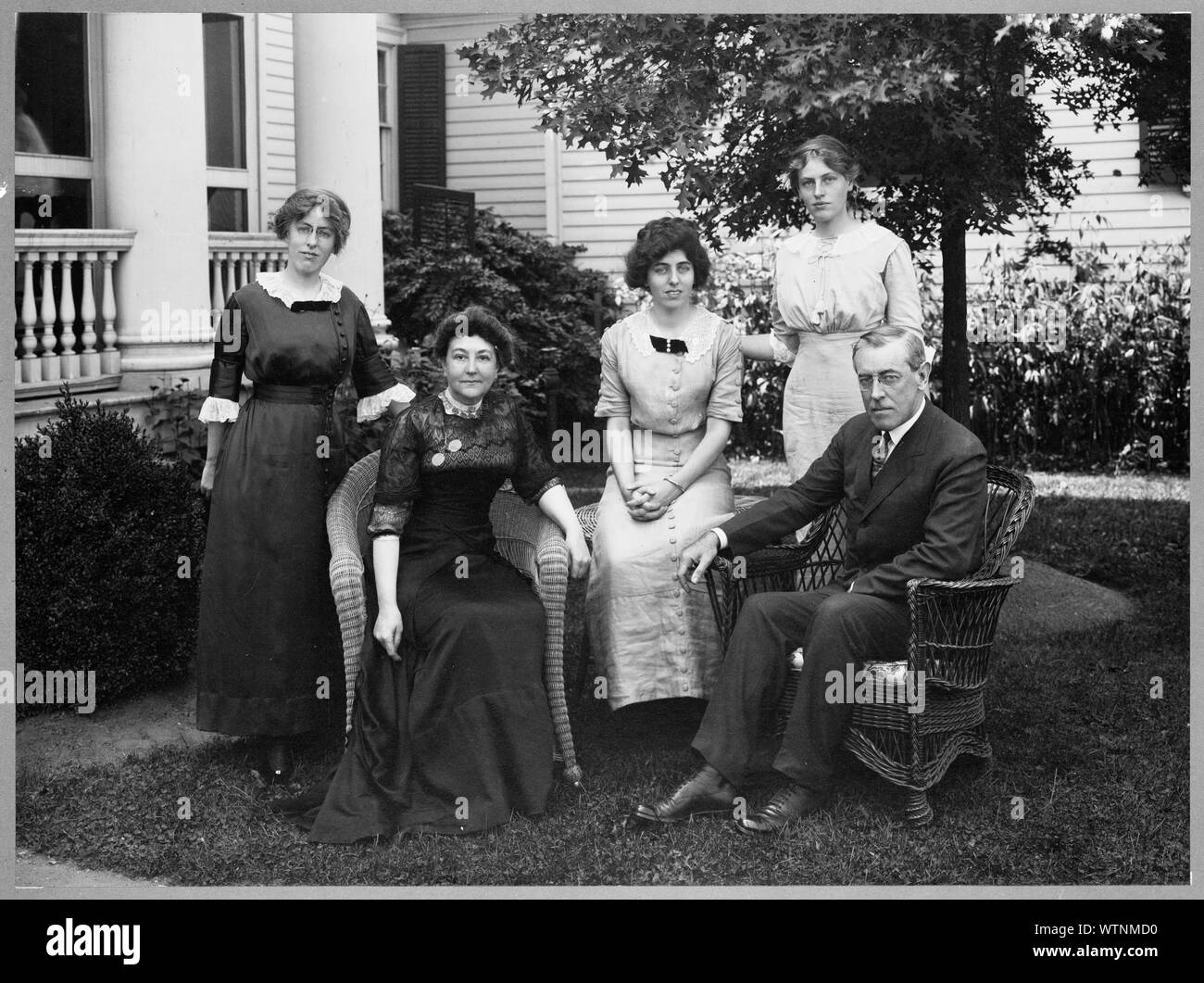 Mr. and Mrs. Woodrow Wilson seated outdoors with their three daughters ...
