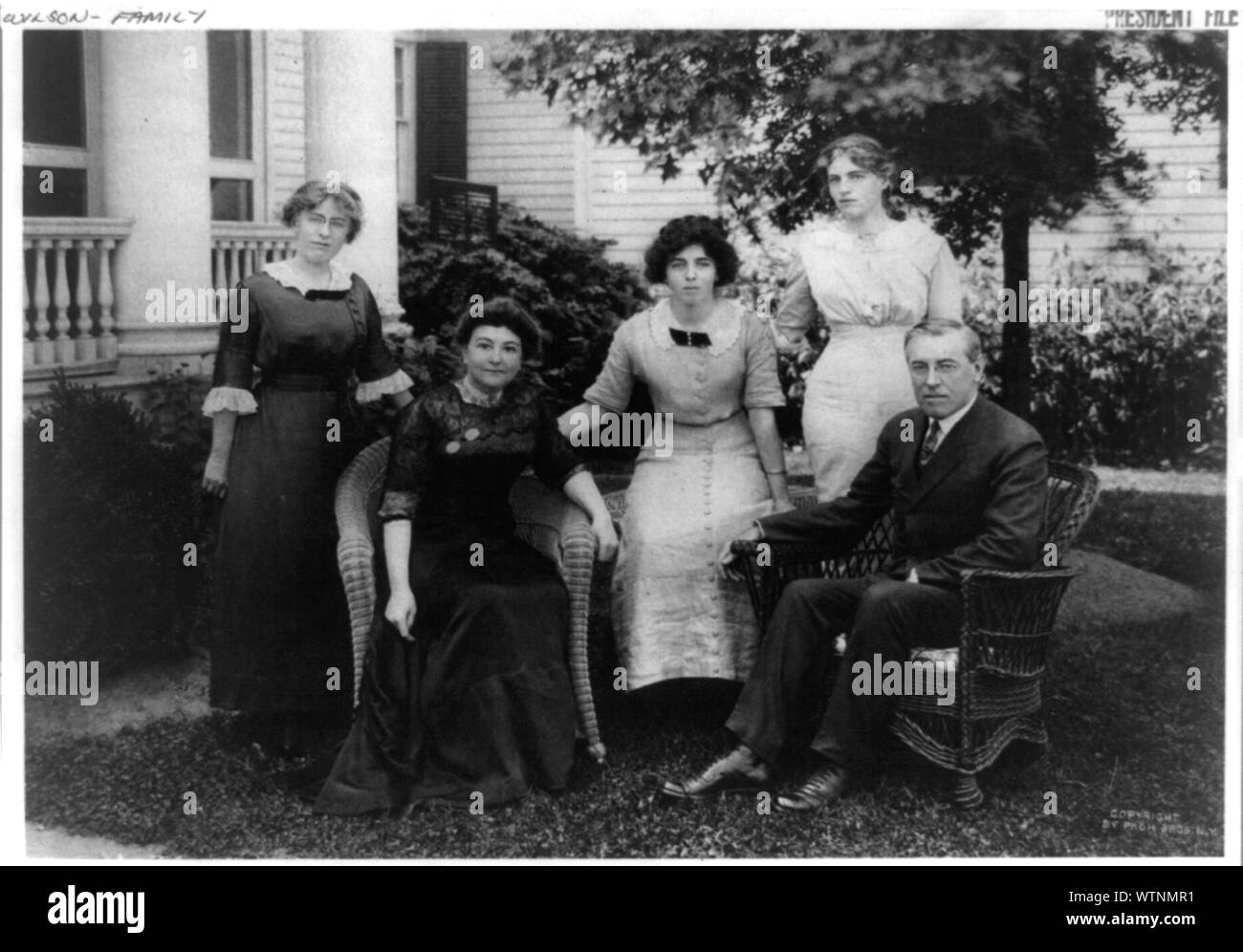 Mr. and Mrs. Woodrow Wilson seated on lawn with their three daughters ...