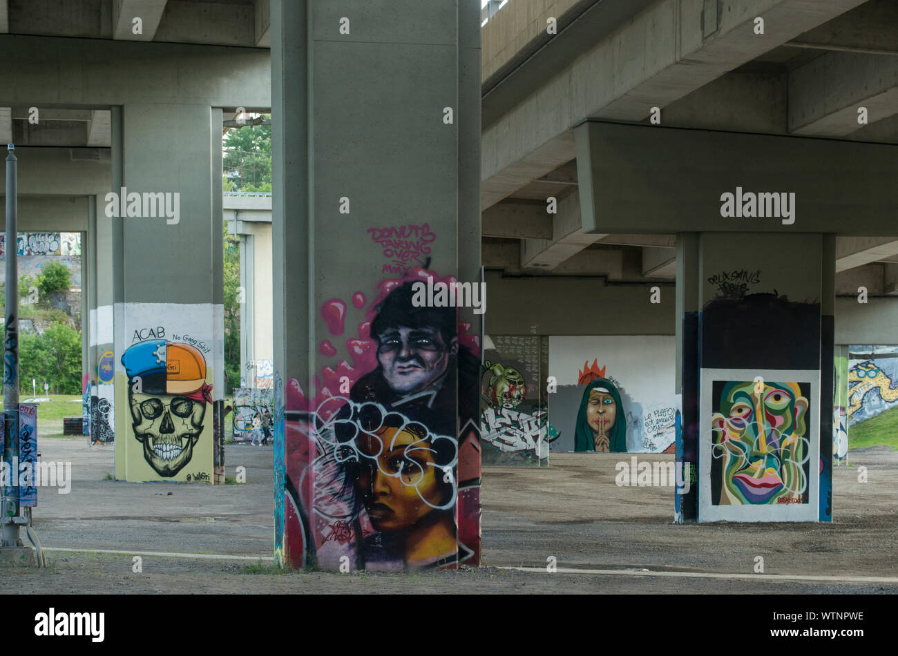 Graffiti / Street art painted on the concrete pillars supporting the ...