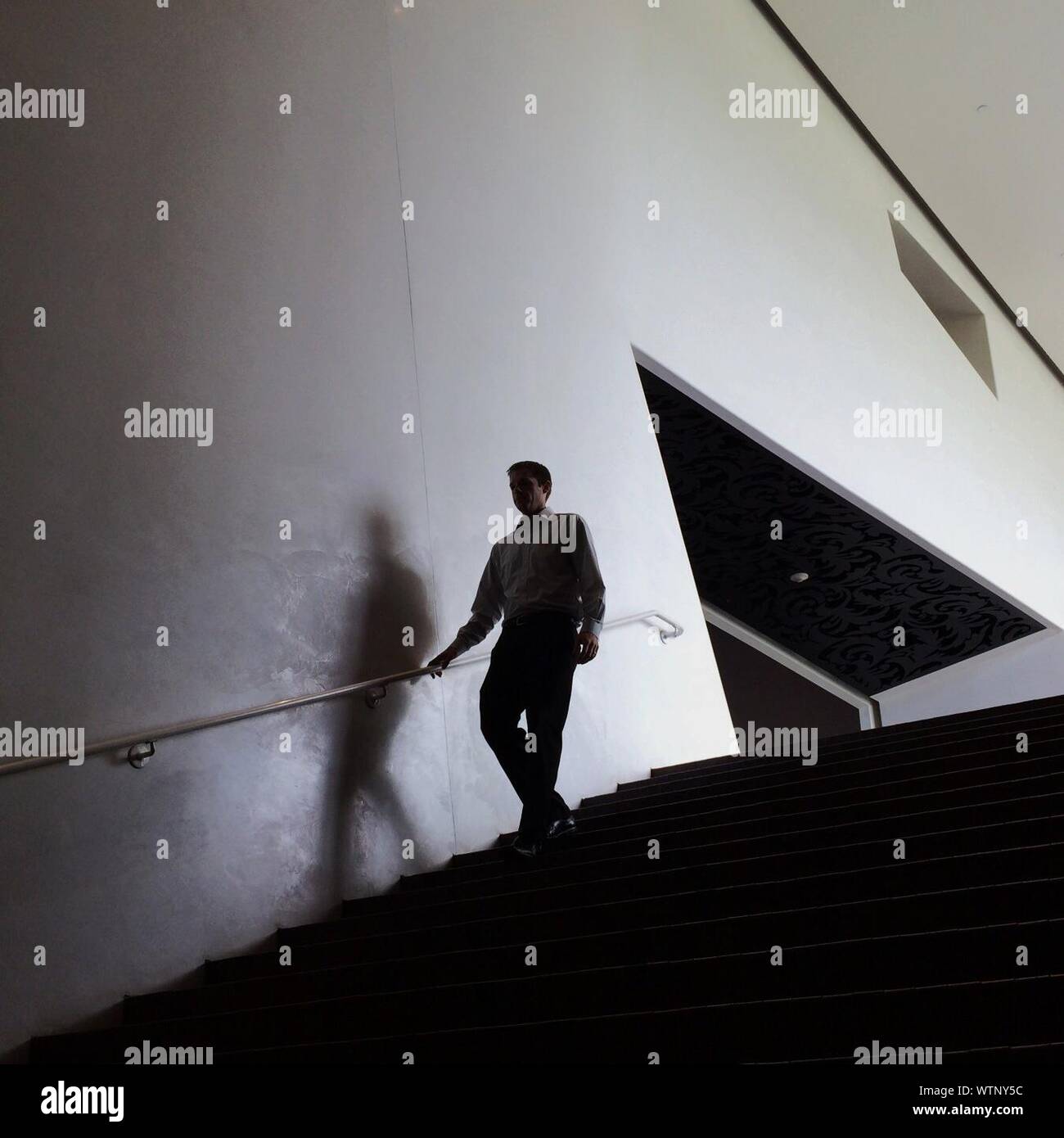 Walking down stairs low angle hi-res stock photography and images - Alamy