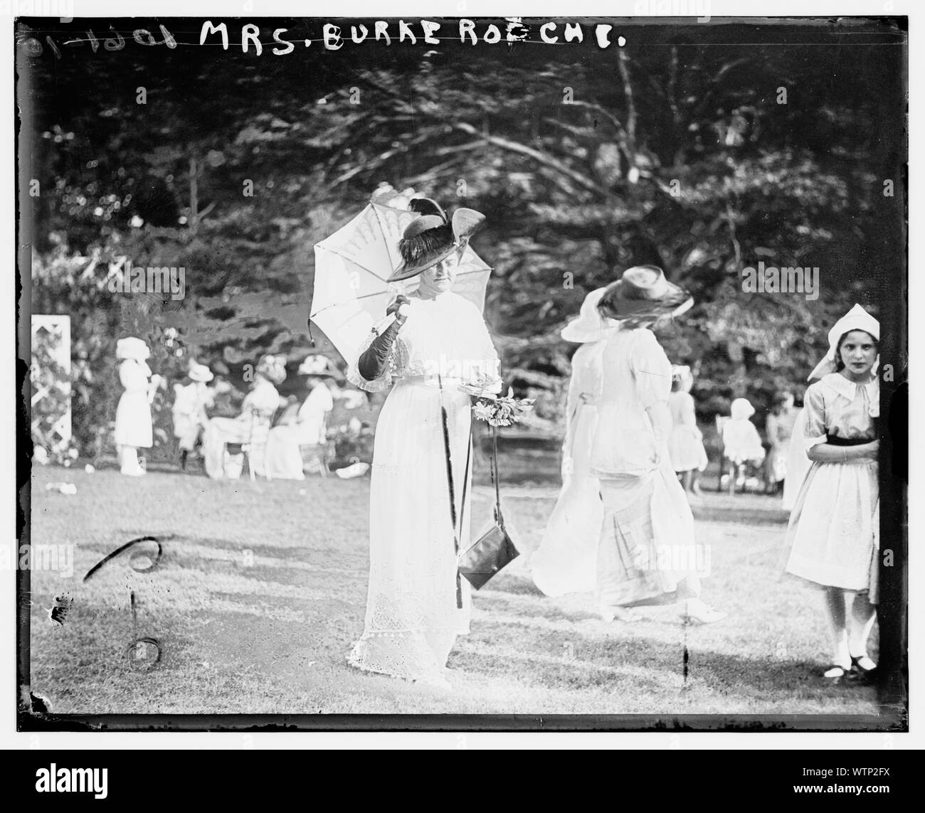 Mrs. Burke Roche on lawn with parasol Stock Photo - Alamy
