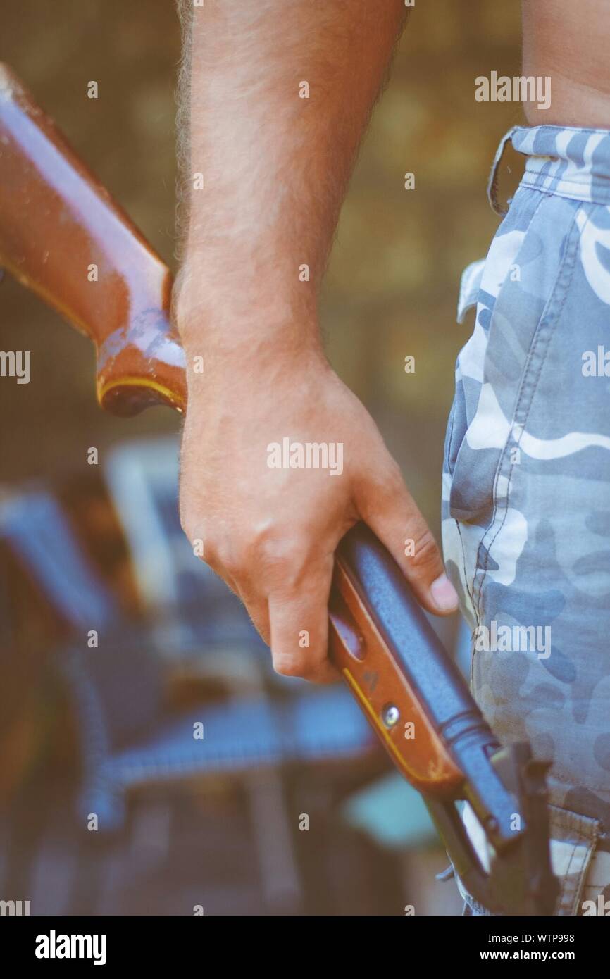 Man holding rifle hi-res stock photography and images - Alamy