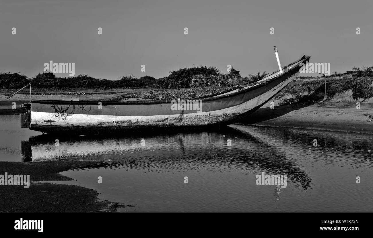 Local colorful fishing boat anchored in the shallow water, copy space ...