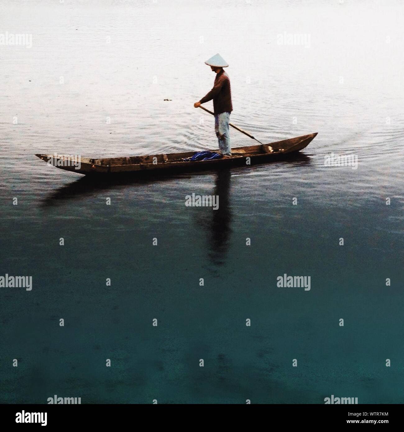Man Wearing Conical Hat On Boat Stock Photo - Alamy