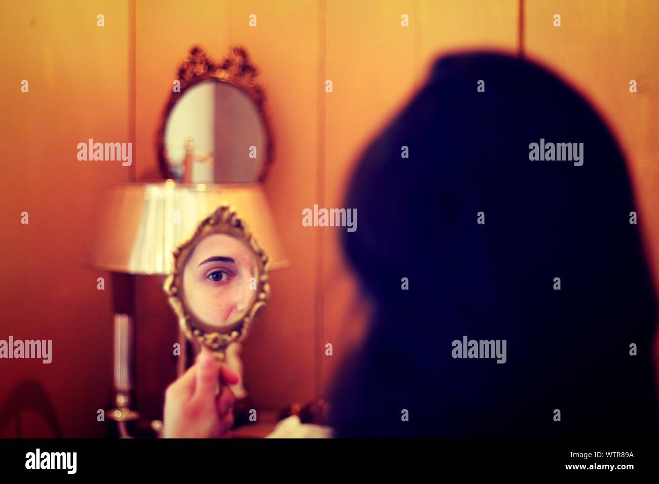 Woman with a hand mirror hi-res stock photography and images - Alamy