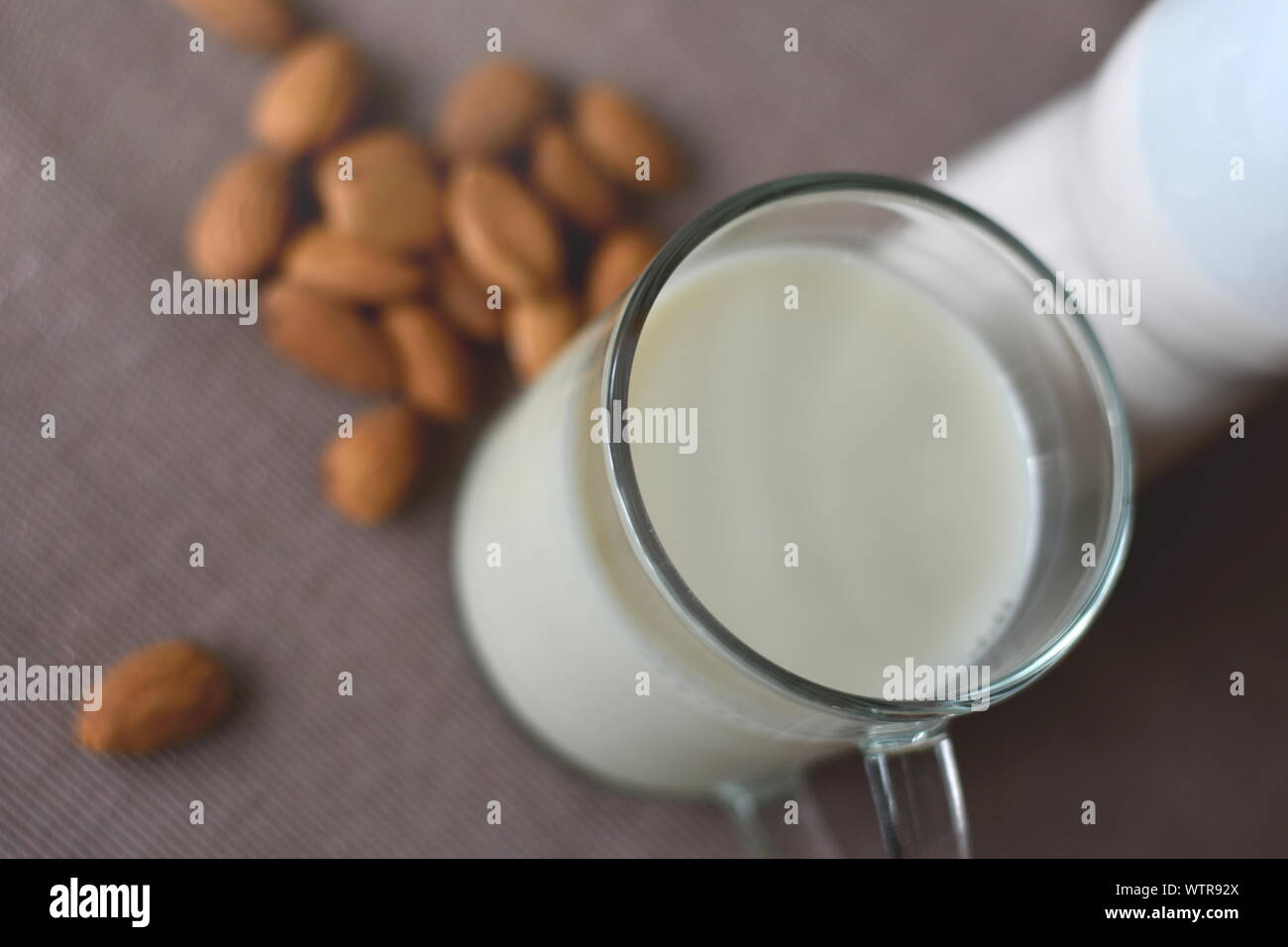 One glass cup full of non-dairy lactose free almond milk. Selective ...