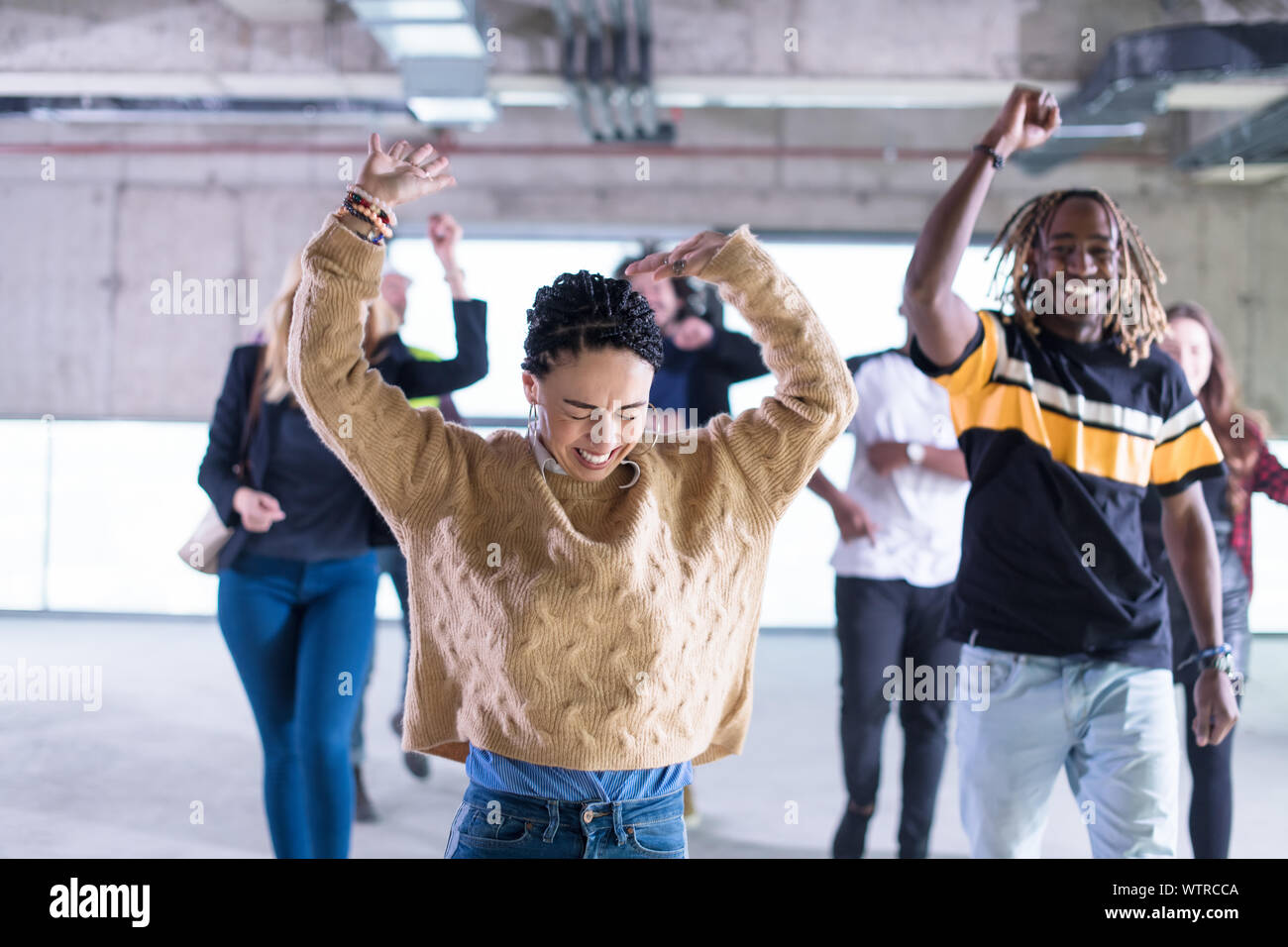 happy multiethnic business team dancing during moving in at new ...