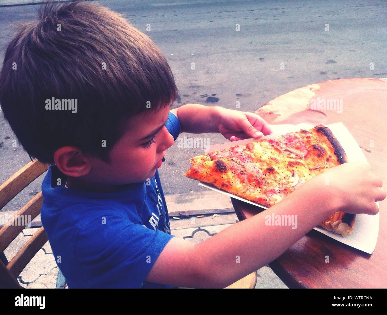 Boy eating pizza hi-res stock photography and images - Alamy