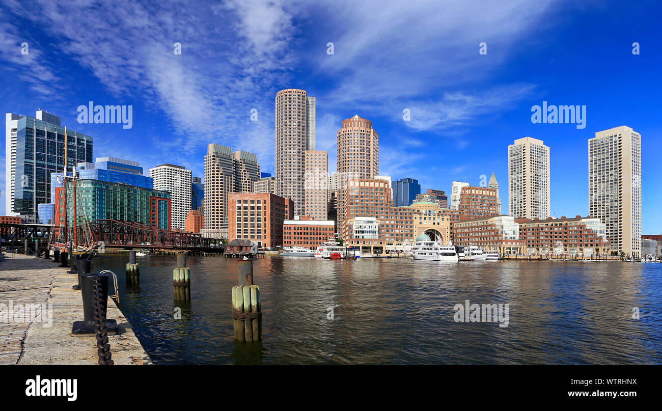 Colorful Boston skyline early morning with skyscraper reflections into ...