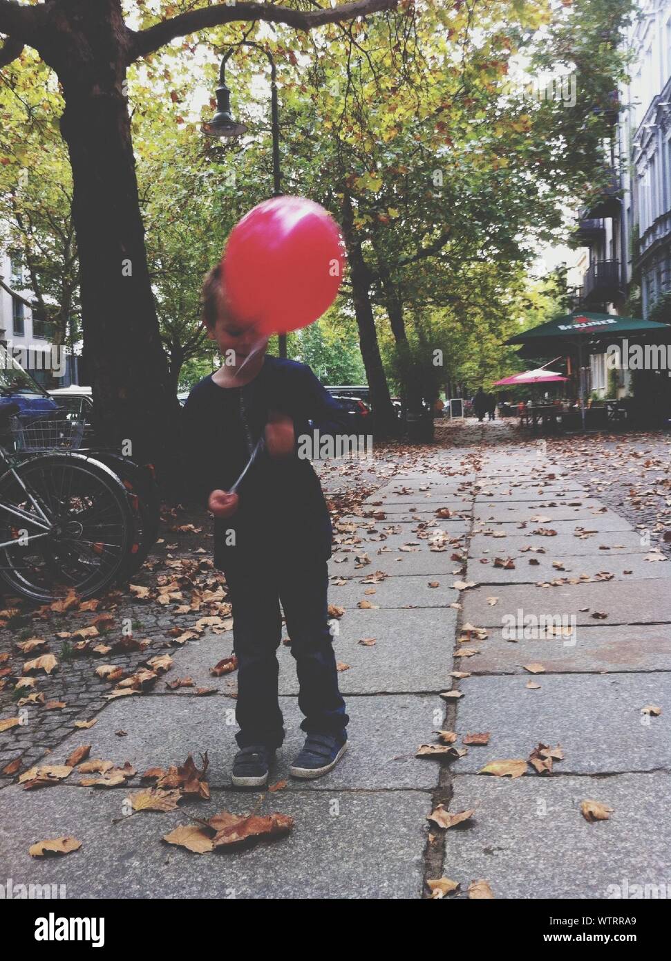 Boy holding balloon hi-res stock photography and images - Alamy