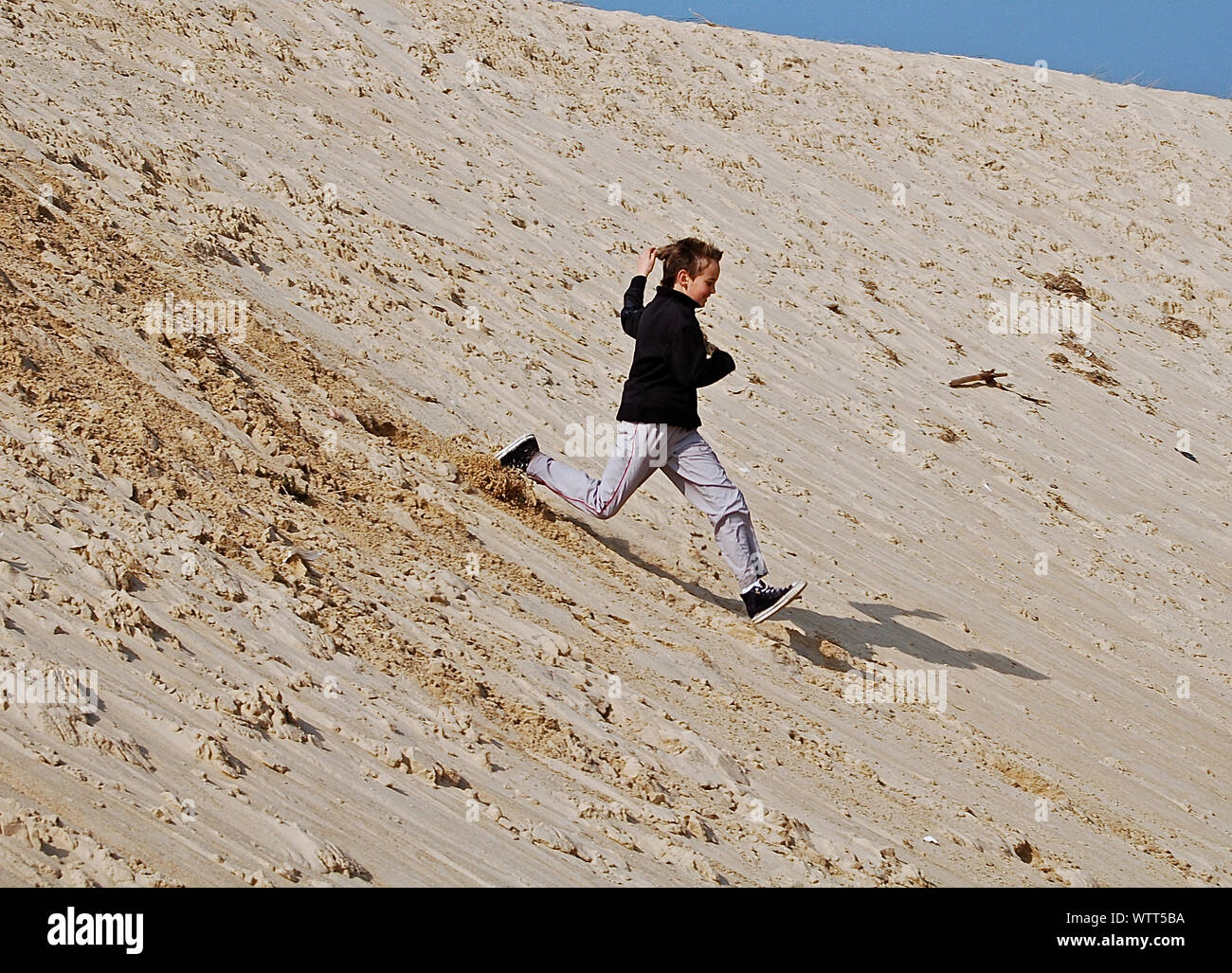 Full Length Of Boy Running On Sand Dunes Stock Photo - Alamy
