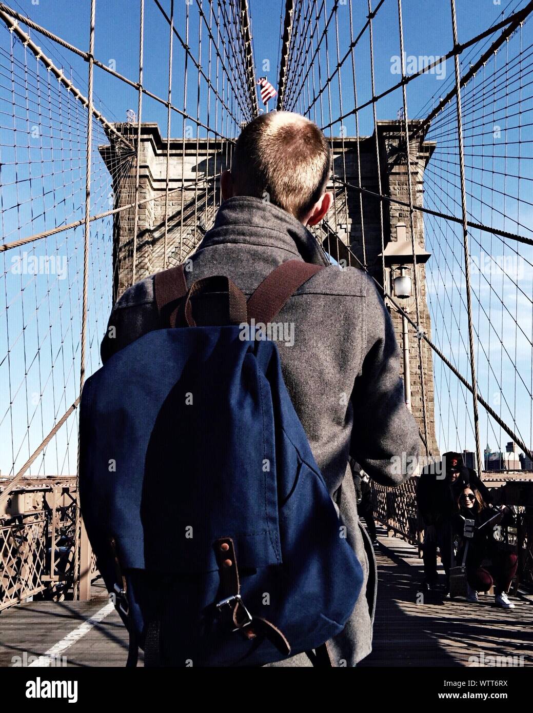 Rear View Of Man Standing At Brooklyn Bridge Stock Photo - Alamy