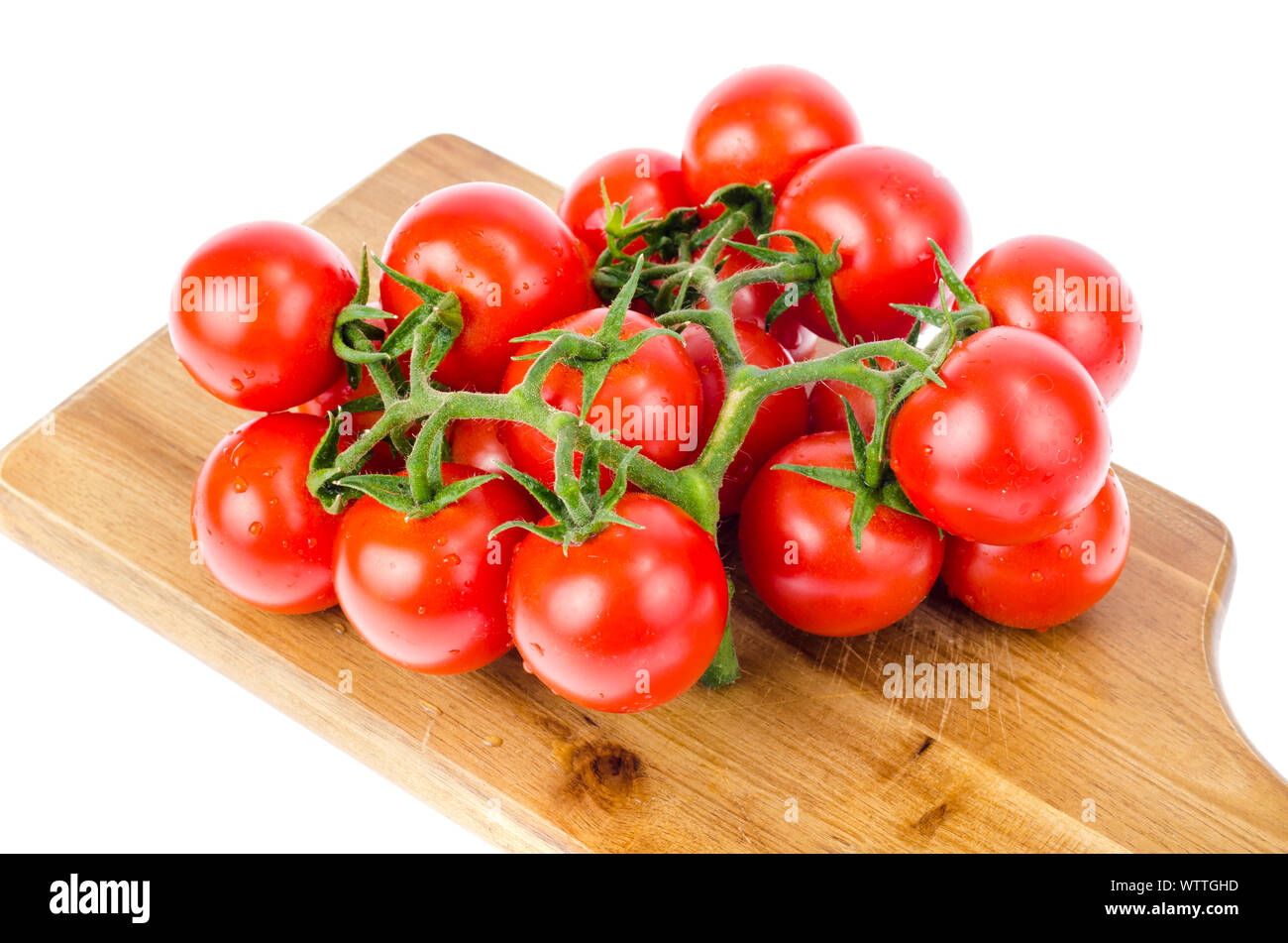 Wooden kitchen board with cherry tomatoes for cooking. Studio Photo ...