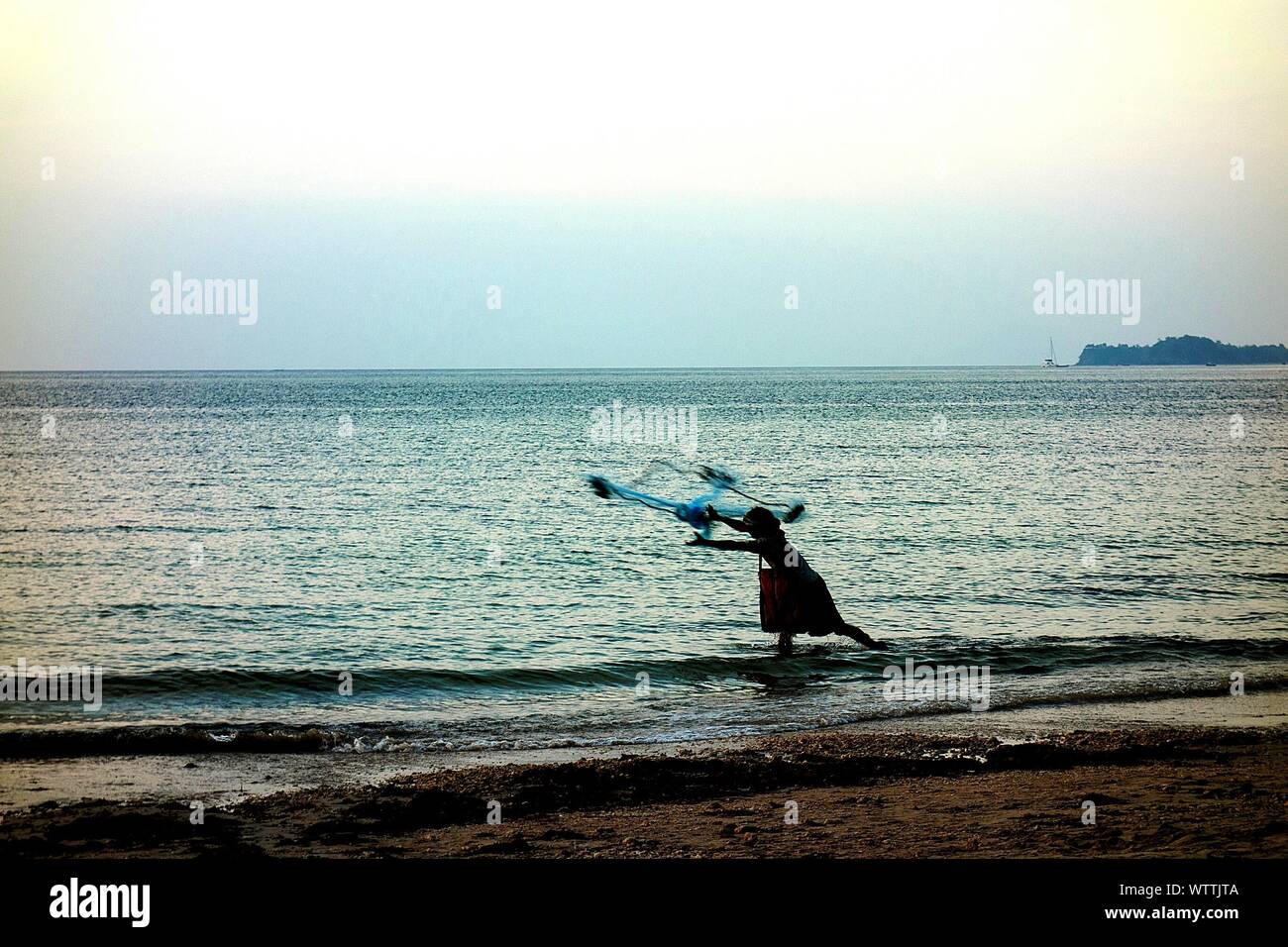 Woman fishing with net beach hi-res stock photography and images - Alamy